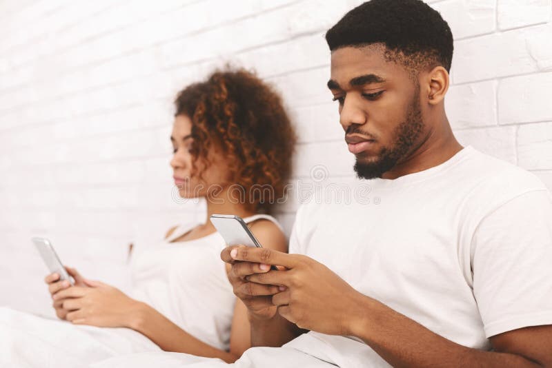 Black Couple Using Cellphones in Bed, Ignoring Each Other Stock Photo ...