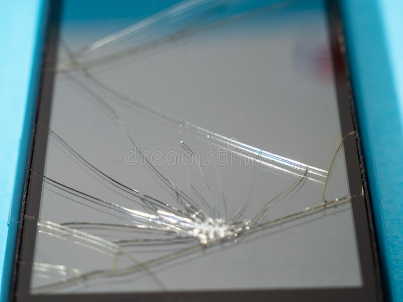 Black Crashed Smartphone with Broken Screen and Body on a Blue Table in ...
