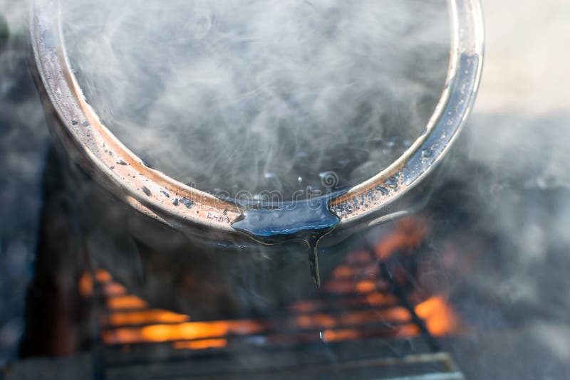 Black Crude Oil Flows Out of Metal Can with Steam on Fire for ...