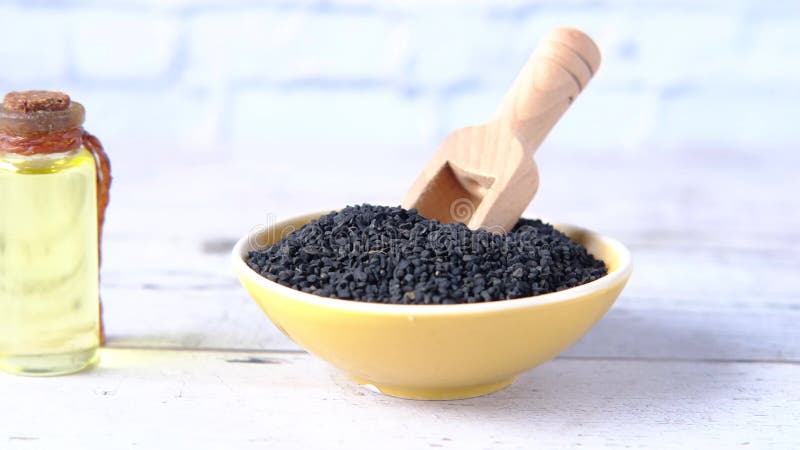 Black Cumin a Container with Oil in a Jar on Table. Stock Footage ...