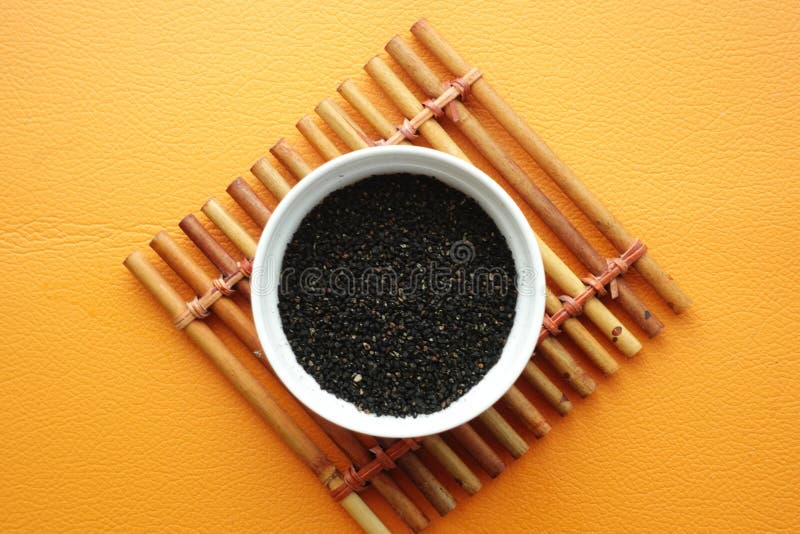 Black Cumin in a Container on Orange Background Stock Photo - Image of ...