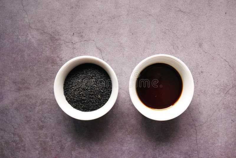 Black Cumin Oils in a Container on Black Background Stock Photo - Image ...