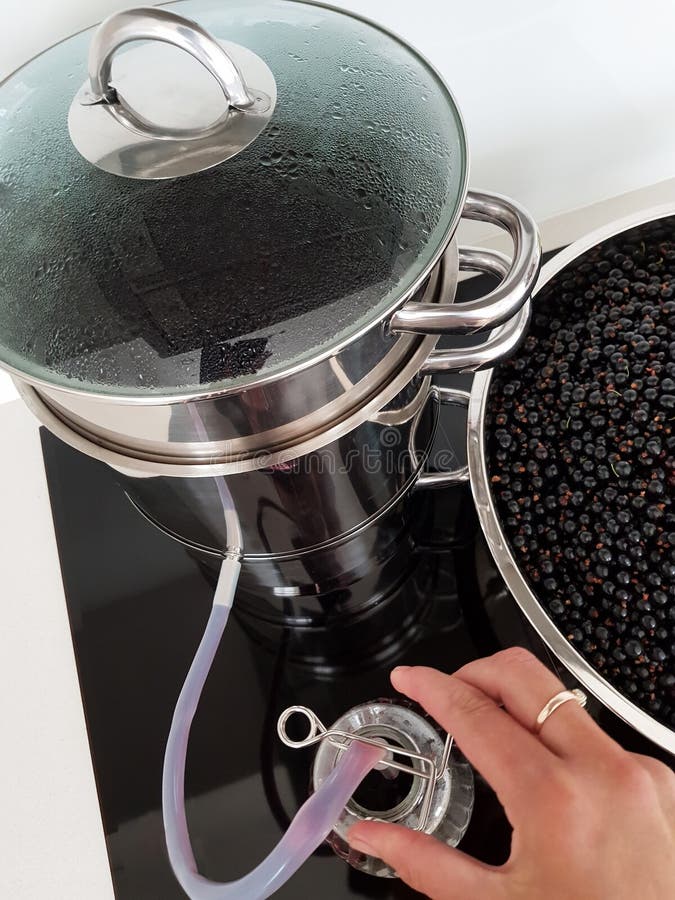 Black Currant Juice Making by Steam Juicer Pot in the Kitchen Stock ...