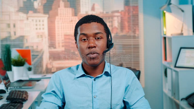 Black Customer Support Agent Working in Busy Call Center by Talking To ...