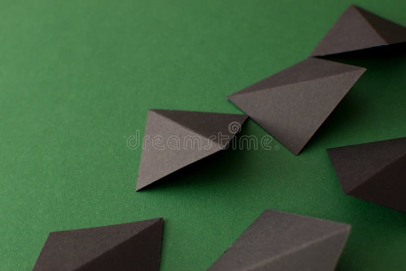 Black 3d Triangle Geometric Shapes on Green Background, Close Up Stock ...