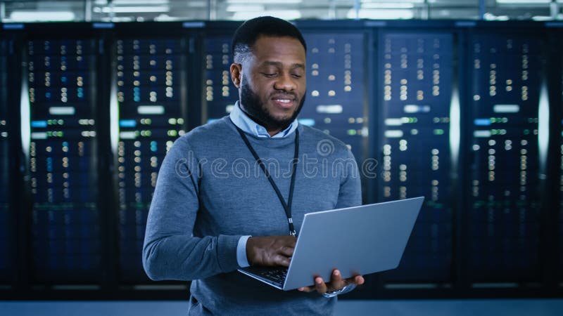 Black Data Center it Technician Standing in the Middle of a Server Rack ...
