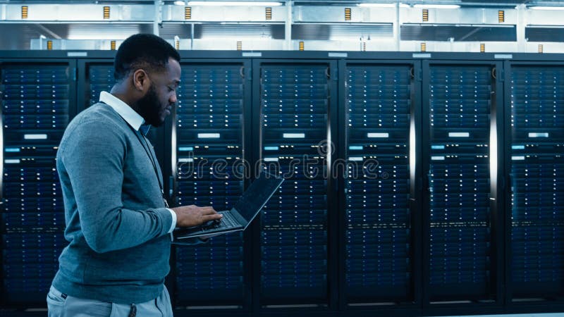 Black Data Center it Technician Walking through Server Rack Corridor ...