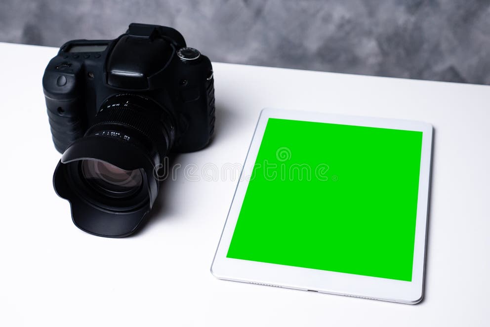 A Black Digital Camera and a Blank Screen Tablet on Table Stock Image ...