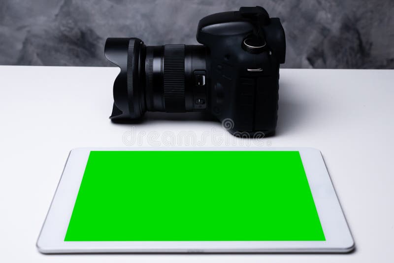 Black Digital Camera and Blank Screen Tablet on Table Stock Photo ...