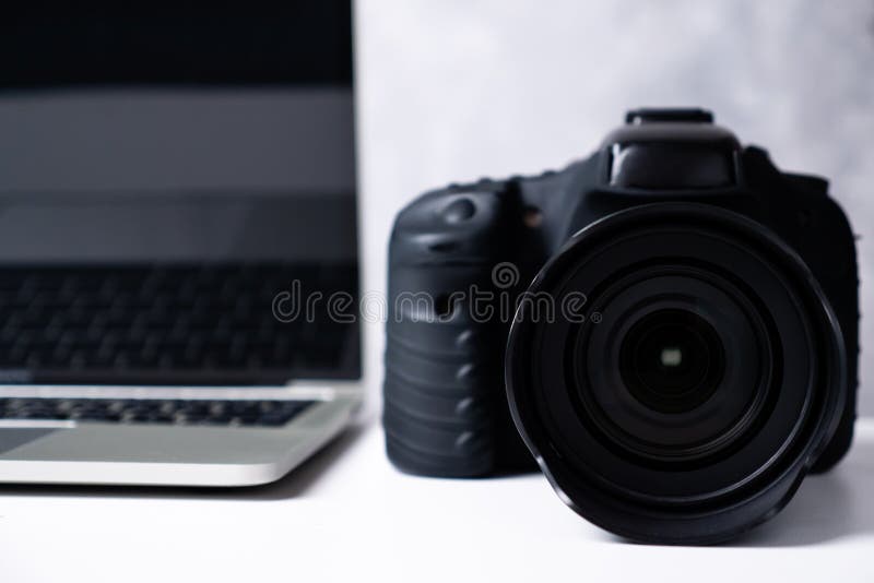 Black Digital Camera and Computer Laptop on a Table Stock Image - Image ...