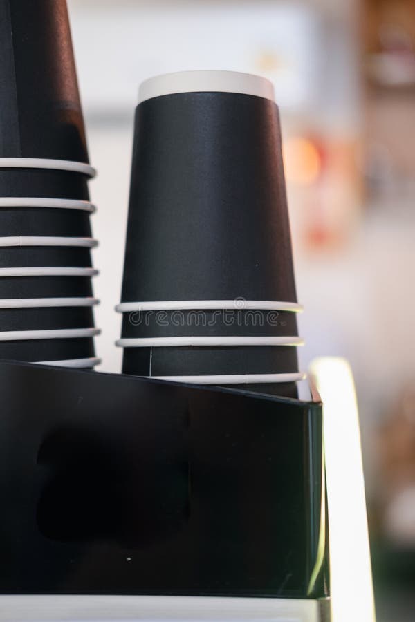 Black Drinking Paper Coffee Cups in Piles on Coffee Machine Stock Photo ...