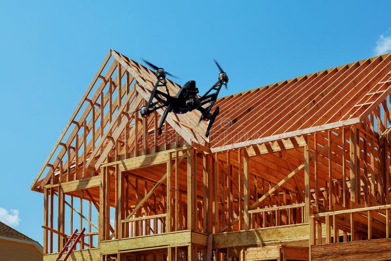 Black Drone Quadcopter with Camera Flying Over Framing of a New House ...