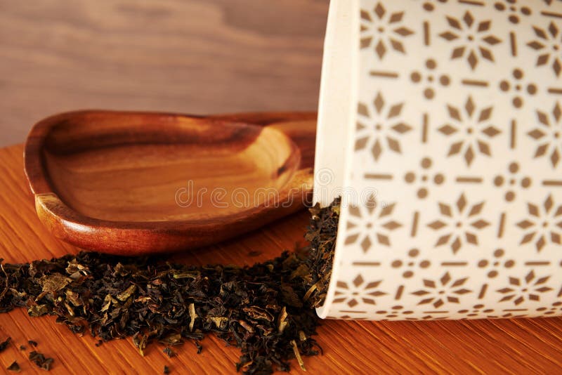 Black Dry Tea Grain Scattered from Container on the Kitchen Table Stock ...