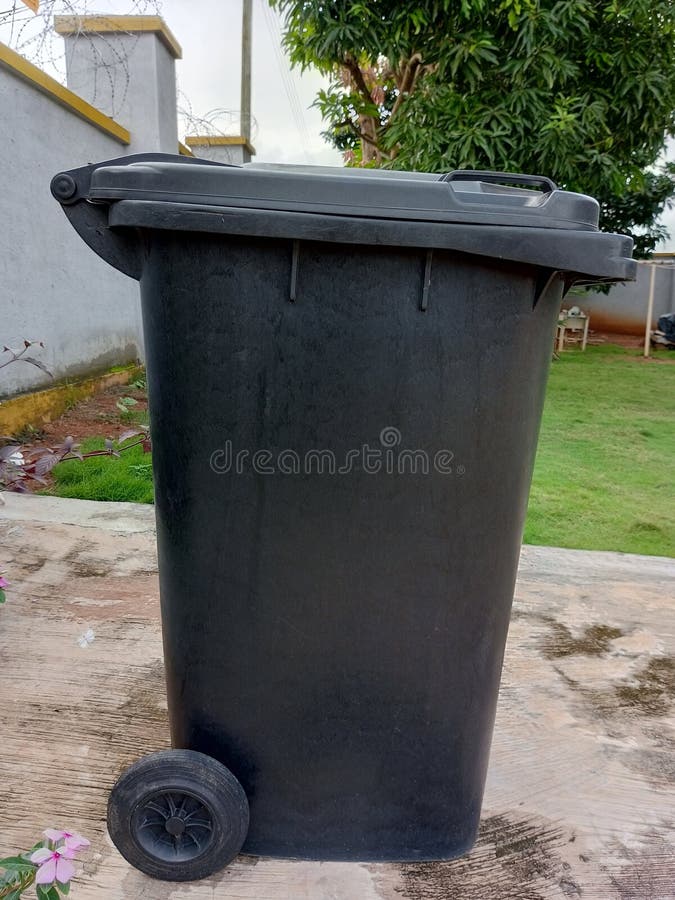 Black Dustbin on a Compound Stock Image - Image of grass, dump: 379364703