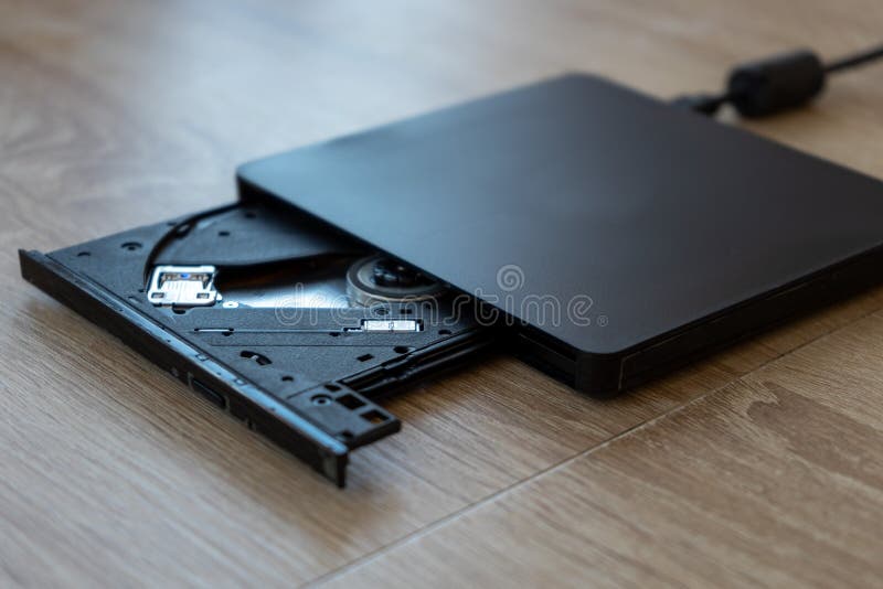 A Black DVD-ROM on a Wooden Table Stock Photo - Image of remusrigo ...