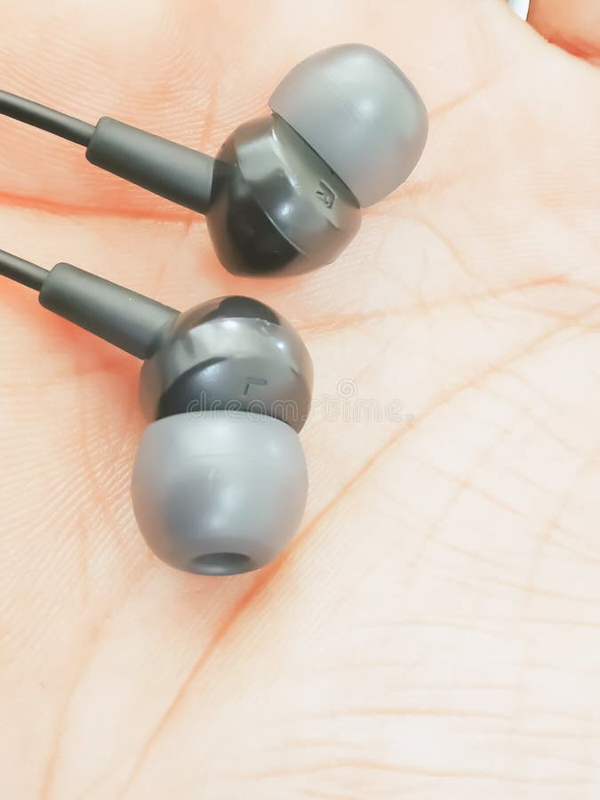 Black Ear Phones on the Hand Stock Photo - Image of hand, music: 165160236