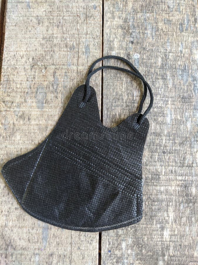 Black Earloop Mask on Wooden Plank Stock Photo - Image of jewellery ...