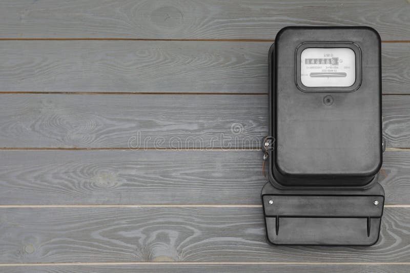 Black Electric Meter on Grey Wooden Background, Top View with Space for ...