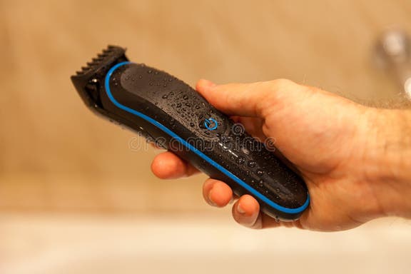 Black Electric Razor in Hand Shower. Stock Image - Image of electricity ...