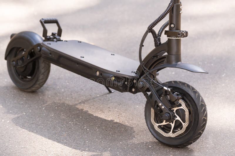 Black Electric Scooter Standing on the Running Board on the Street ...