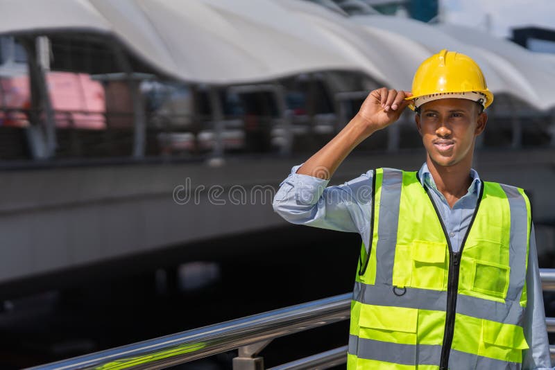 Black Engineer Catch Helmet and Looking at Construction Site Outside ...