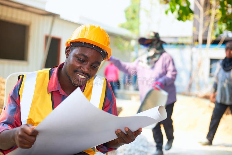 Black Engineer or Contractor Examines the Blueprints Inside the Site ...
