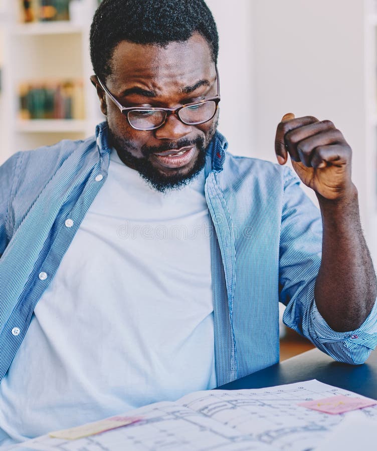 Black Engineer Reviewing Blueprint in Office Stock Image - Image of ...