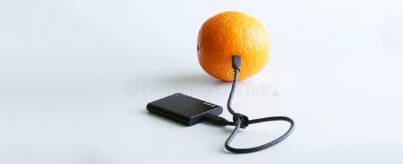 Black External SSD is Wired To a Fresh Orange. Concept of Green ...