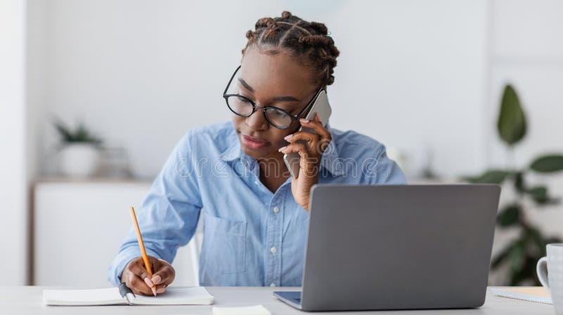 Black Female Office Worker Talking on Cellphone with Client and Taking ...