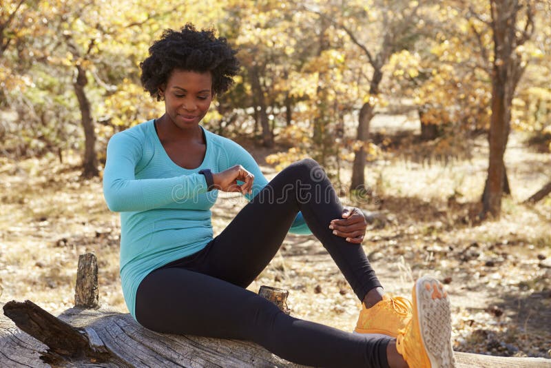 Black Female Runner Sitting Forest Checking Smartwatch Stock Photos ...
