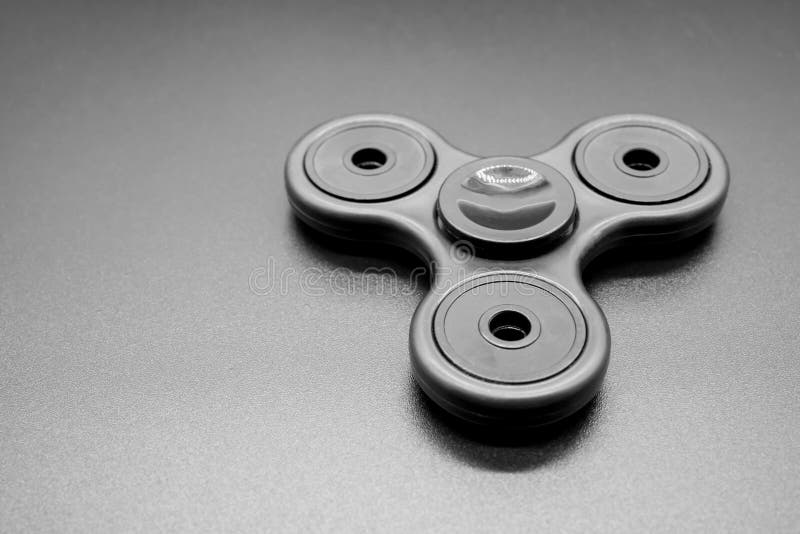 Black Fidget Aluminum Spinner with Metal Balls Inside Each Arm on Black ...