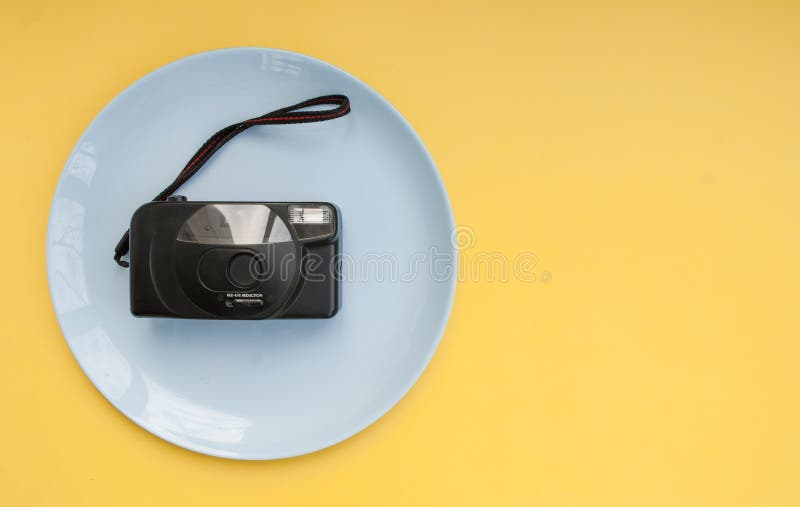 Black Film Camera on a Blue Circle, Orange Background. Flat Lay. Top ...