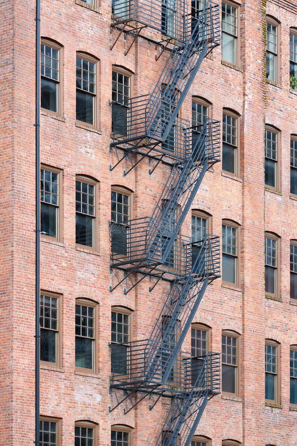 Black Fire Escape on the Side a a Red Brick Building with Repeating ...