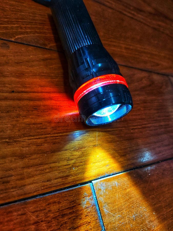 A Black Flashlight Lying Brightly Lit. Stock Image - Image of ...