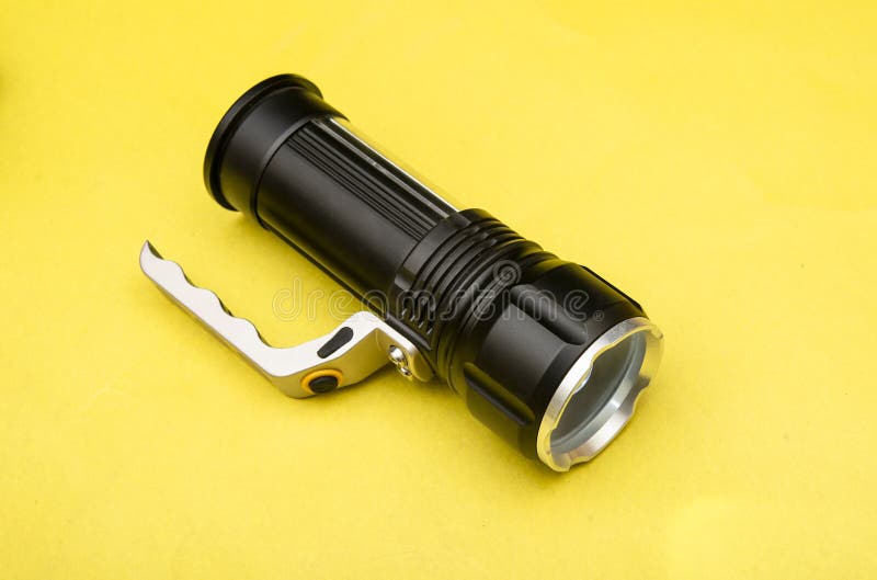 Black Flashlight on Yellow Table Banner Top View Stock Image - Image of ...