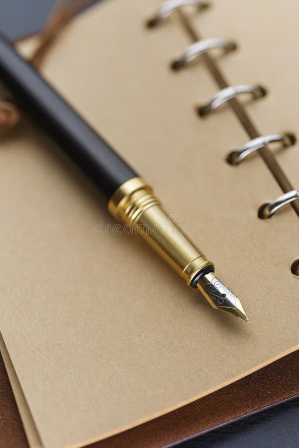 Black Fountain Pen on a Notebook with Yellow Pages Stock Photo - Image ...