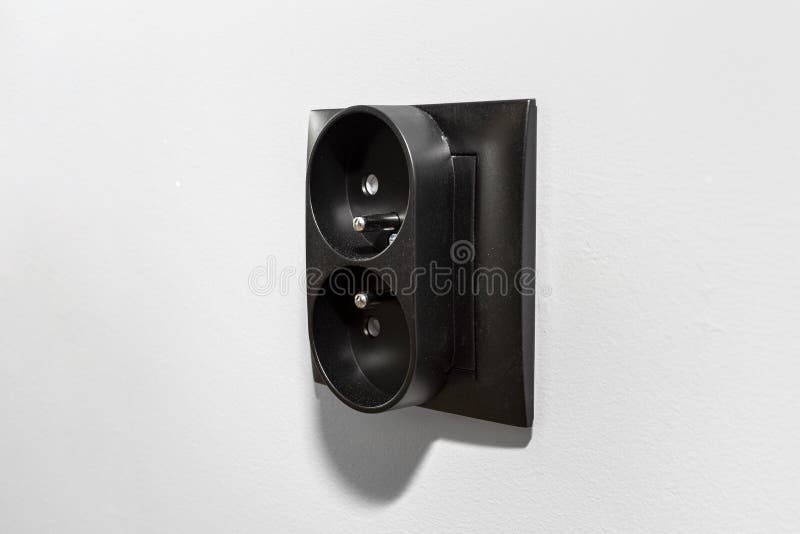 Black Frame of a Double Electrical Socket with Grounding on the Gray ...