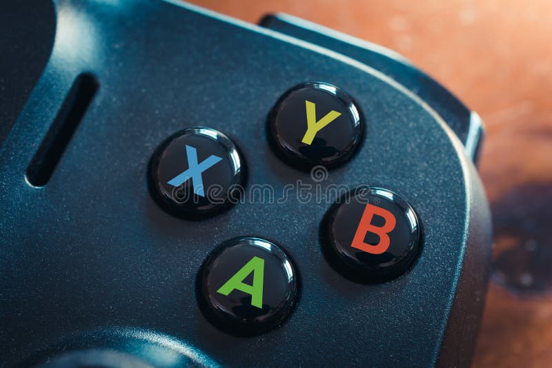 Black Gaming Controller on Table with Focus on the 4 Action Buttons a ...