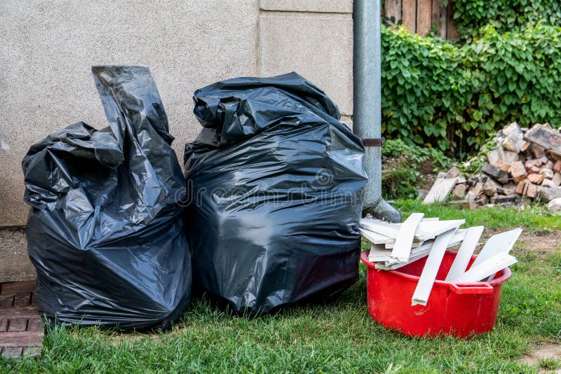 Black Garbage Bags on the Wall of the Building. Garbage Collection ...