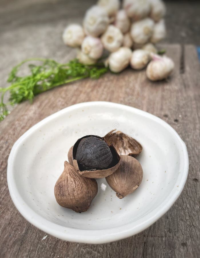 Black Garlic on Wood Background Stock Image - Image of healthy, green ...