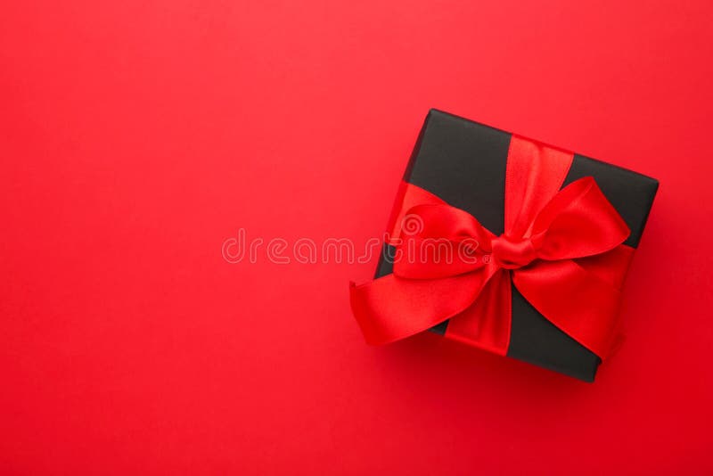 Black Gift Box with Red Ribbon and Bow on Red Background Stock Image ...
