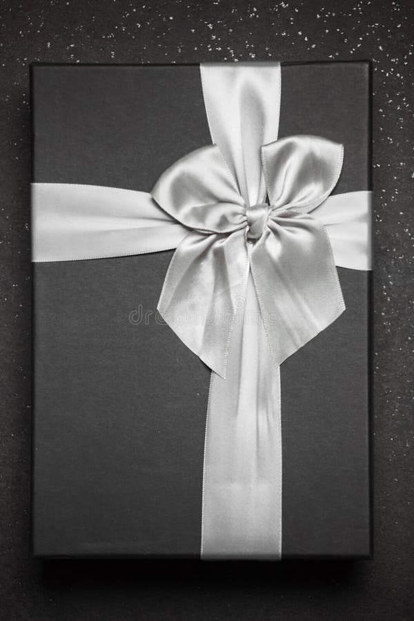 Black Gift Box with a Silver Ribbon and a Large Bow on a Granite Dark ...