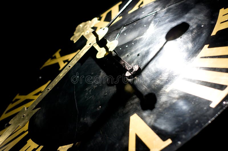 Black and Gold Clock in the Dark Reflecting Light Stock Photo - Image ...