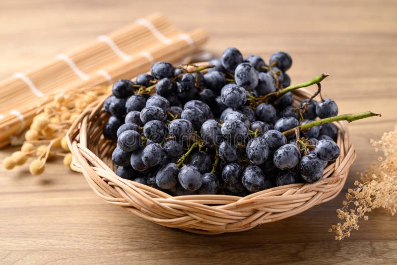 Black Grapes in Basket on Wooden Table Stock Photo - Image of ...