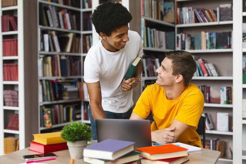 Black Guy Offering Support To His Classmate in Library Stock Photo ...