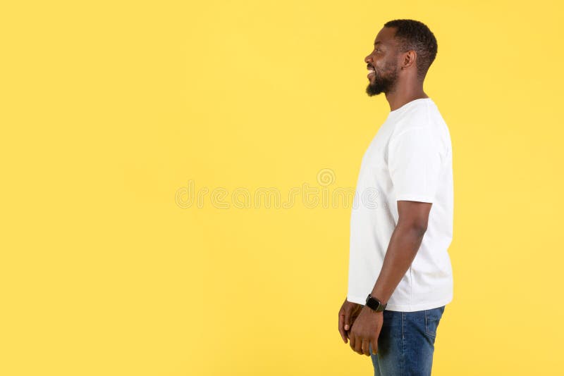 Black Guy Standing Looking Aside Over Yellow Background, Side View ...