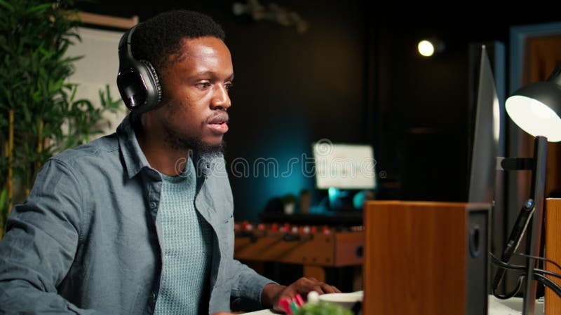 Black Guy Video Editor Working with Dual Monitors for Creative Content ...