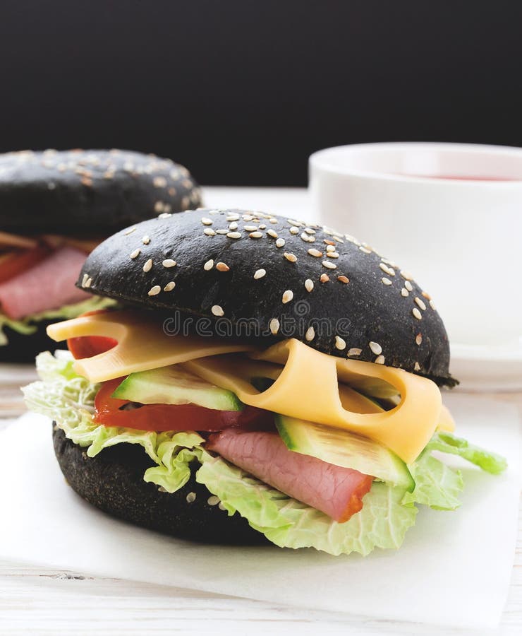 Black Hamburger , Cup of Tea for Breakfast. Stock Photo - Image of ...