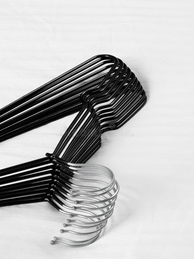 A Black Hanger is Casually Resting on a Pristine White Cloth Stock ...