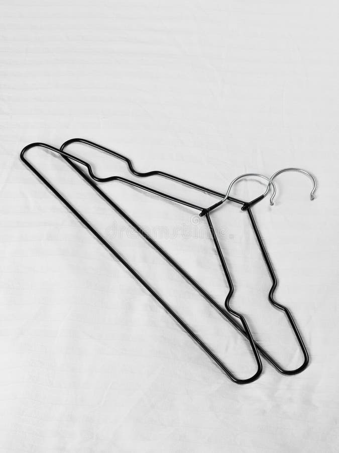 A Black Hanger is Casually Resting on a Pristine White Cloth Stock ...